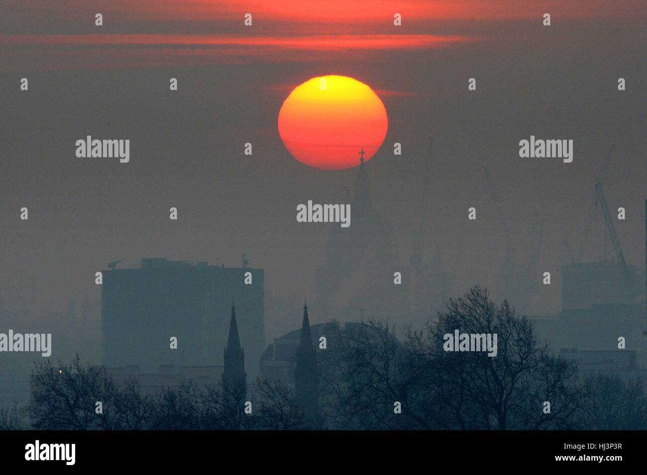 St Paul's cathedral is lit through a misty sunrise from Primrose Hill ...
