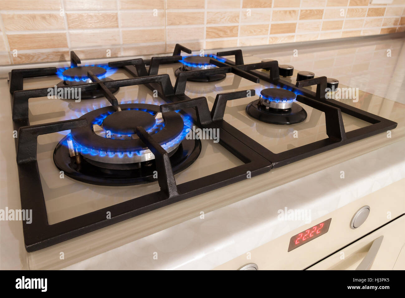 Closeup shot of blue fire from domestic kitchen stove. Gas cooker with ...
