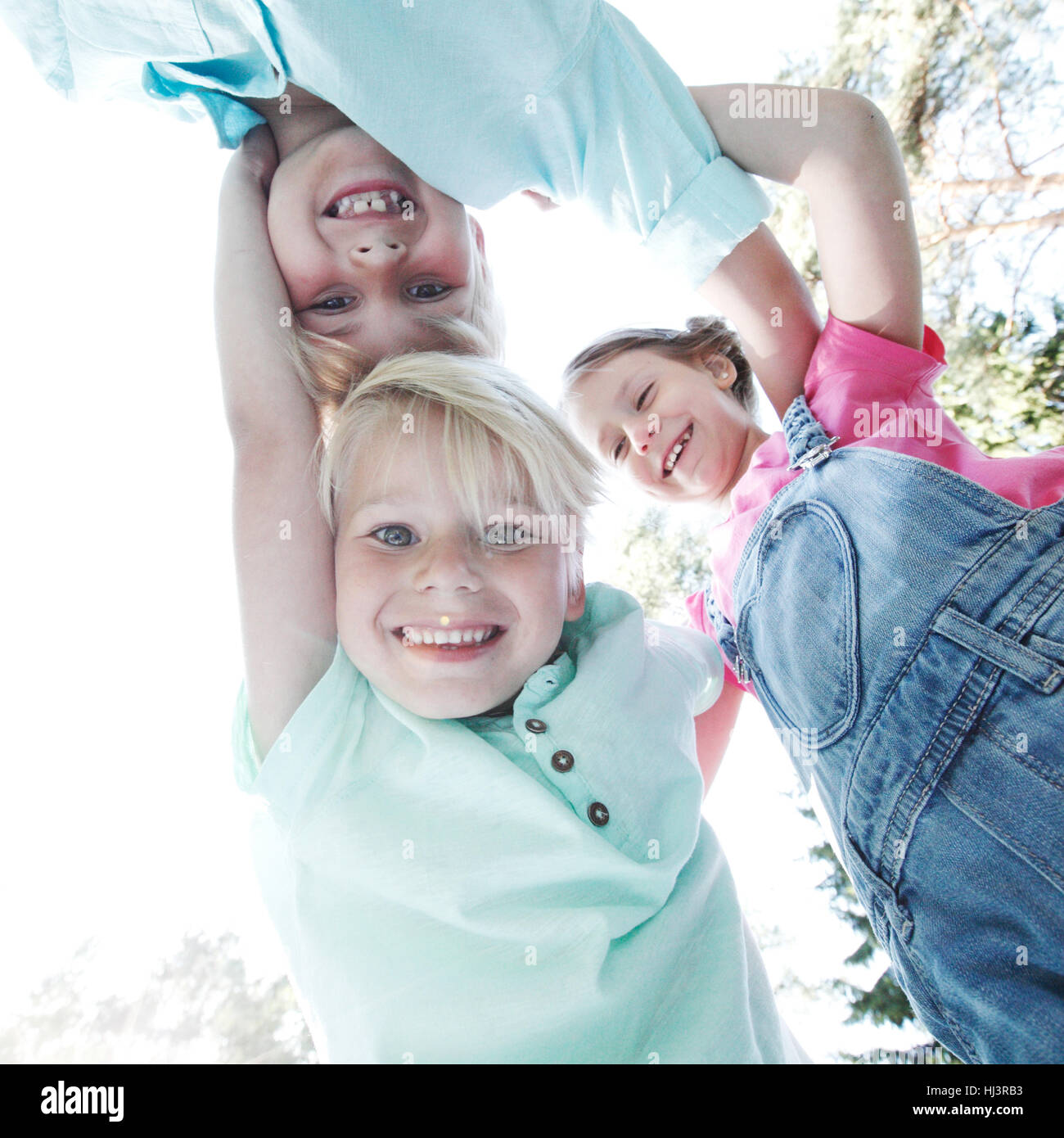 Group of smiling children looking down into camera Stock Photo - Alamy