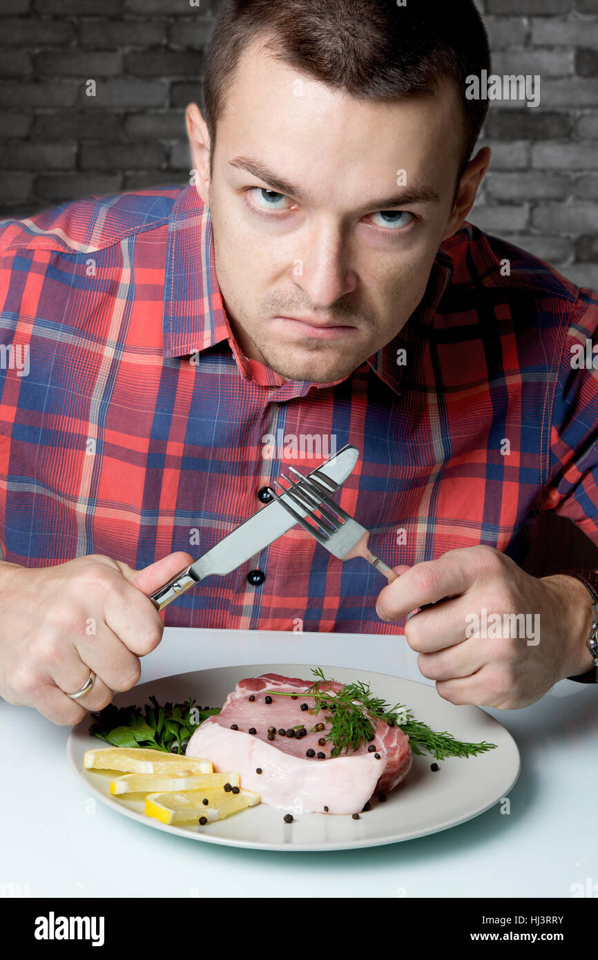Angry man table fork hi-res stock photography and images - Alamy