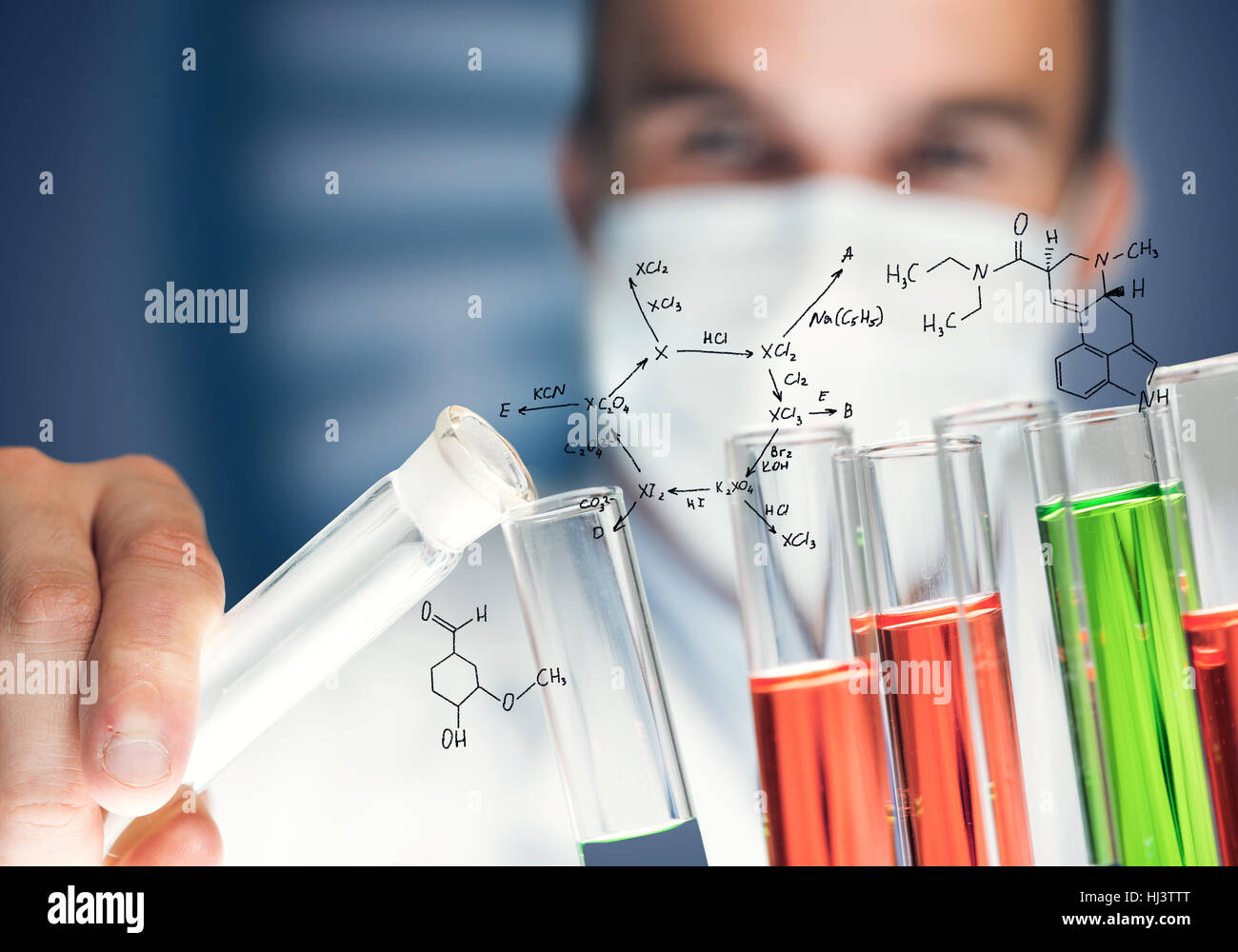 Young scientist mixing reagents in glass flask in clinical laboratory ...