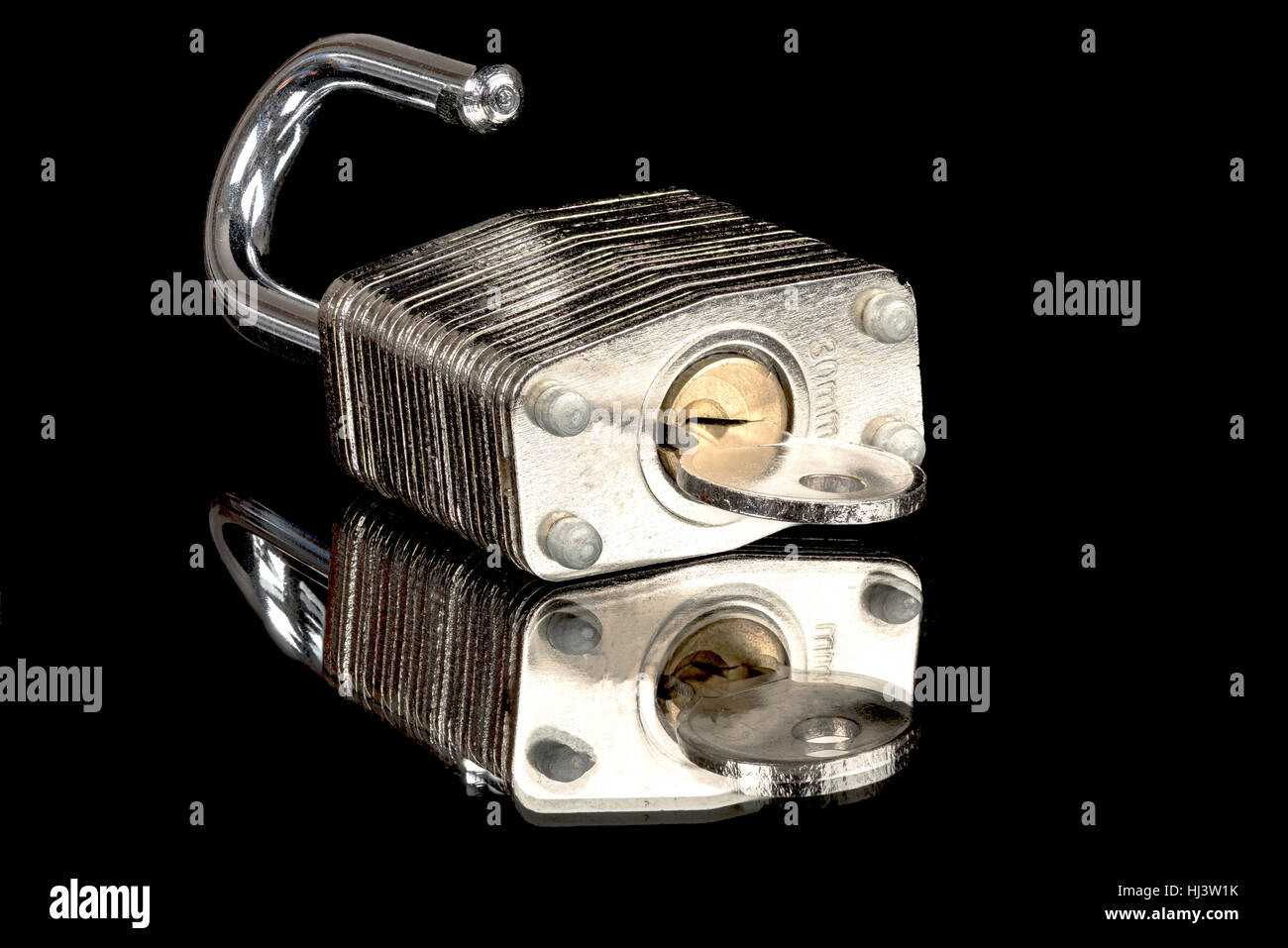 Padlock with a key that has been inserted Stock Photo - Alamy