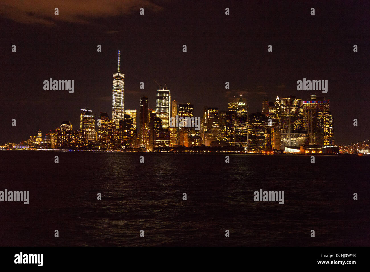 Manhattan island at night photographed from the Staten island ferry ...