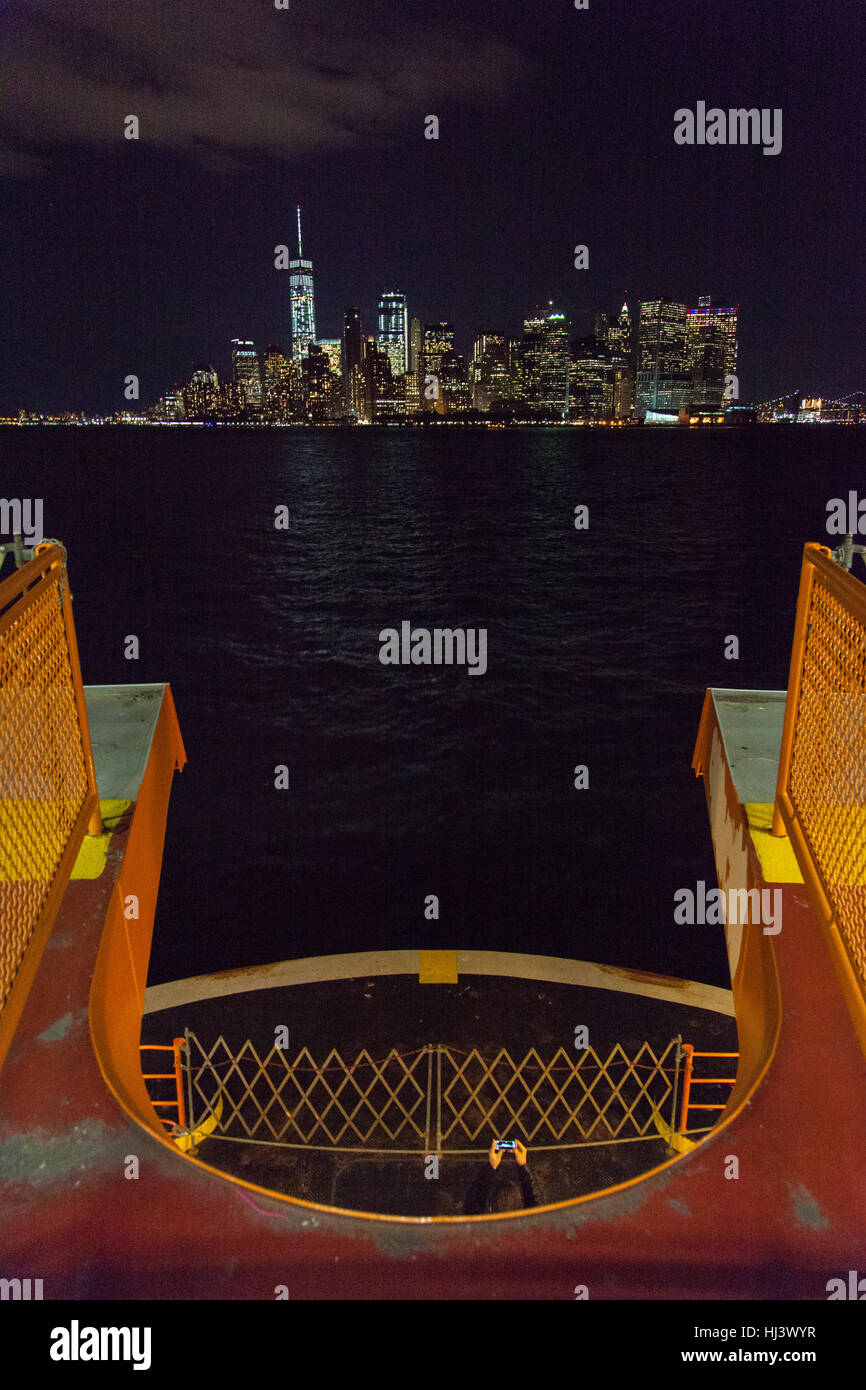Manhattan island at night photographed from the Staten island Ferry ...
