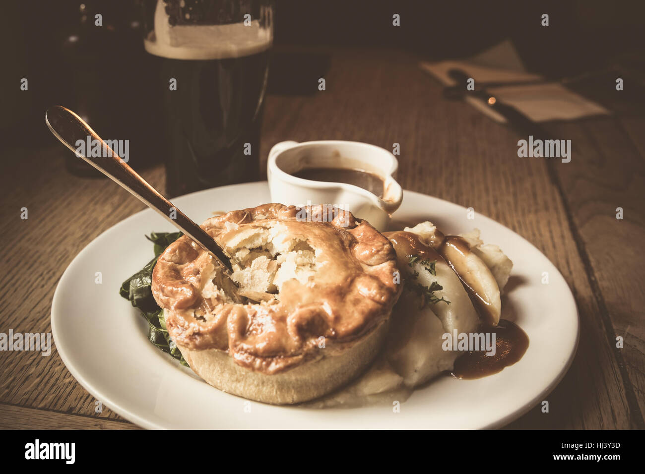 Traditional savory chicken pot pie served in pub with beer in the ...