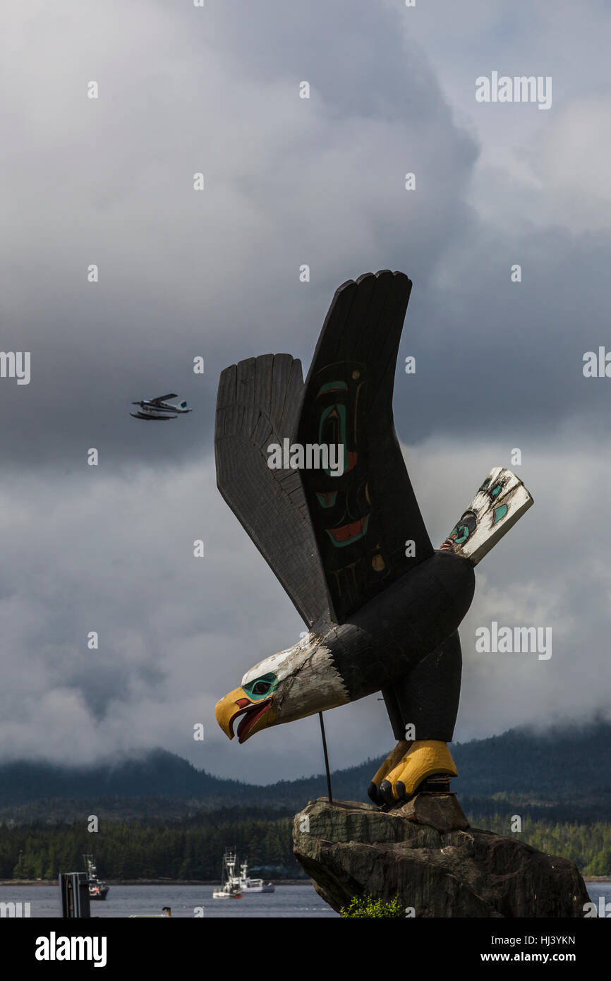 Bald Eagle statue in Ketchikan with float plane in sky Stock Photo - Alamy