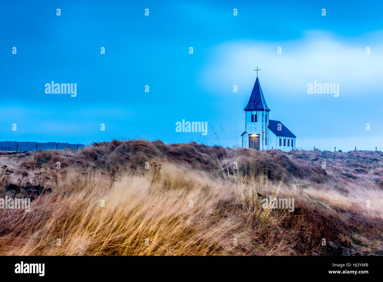 An old church in a remote countryside in Iceland during a rainy, stormy ...