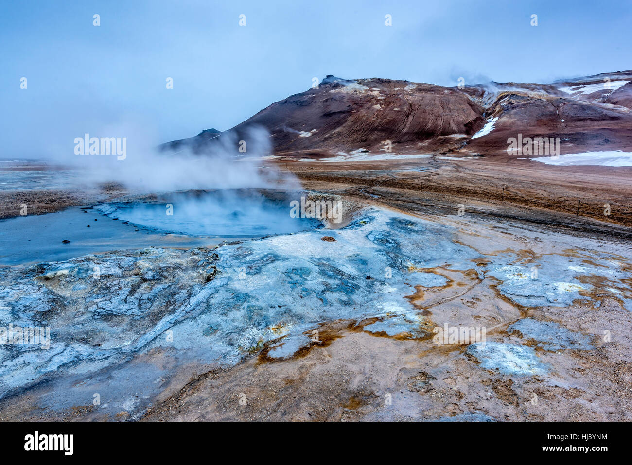 Natural steam rising from volcanic vents in the earth at Hverir in ...