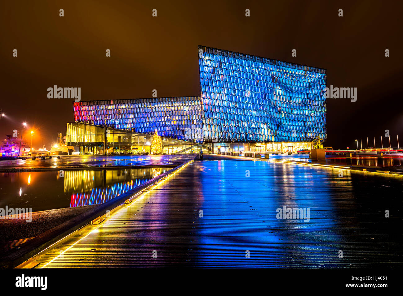 Harpa concert hall in Iceland at night lights up in multiple colors ...
