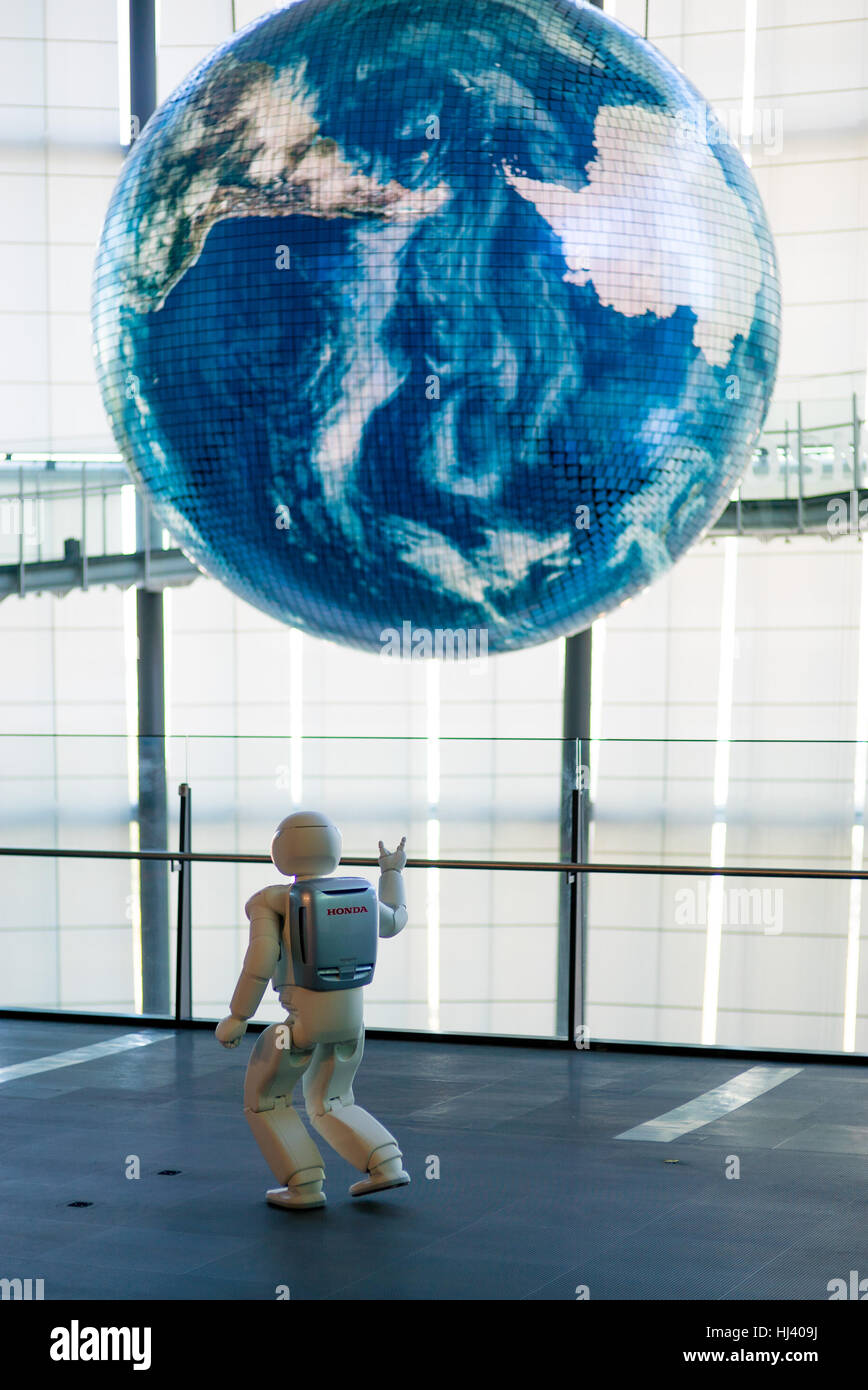 Honda's ASIMO robot points towards a model globe at The National Museum ...