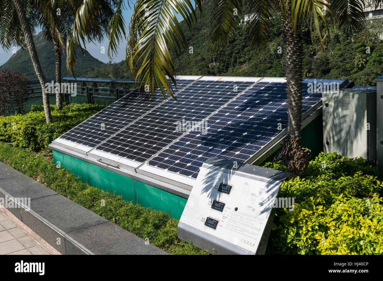 Solar panels with green hills in the background Stock Photo - Alamy