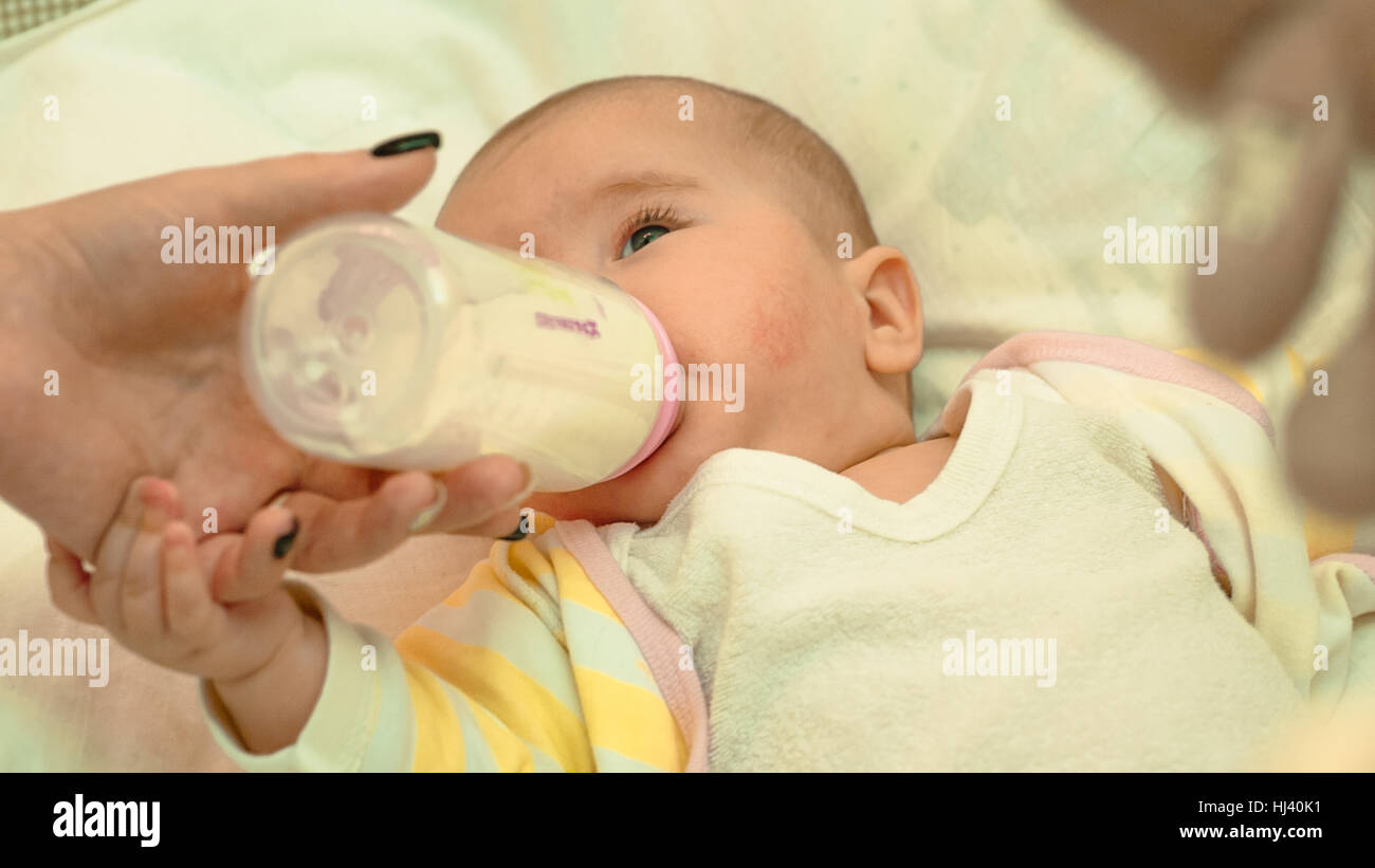 Little newborn baby drinking milk from a bottle Stock Photo - Alamy
