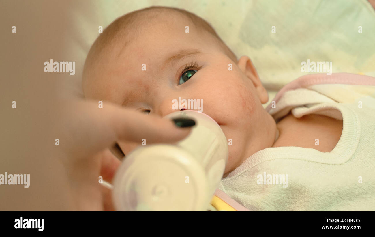 Little newborn baby drinking milk from a bottle Stock Photo - Alamy