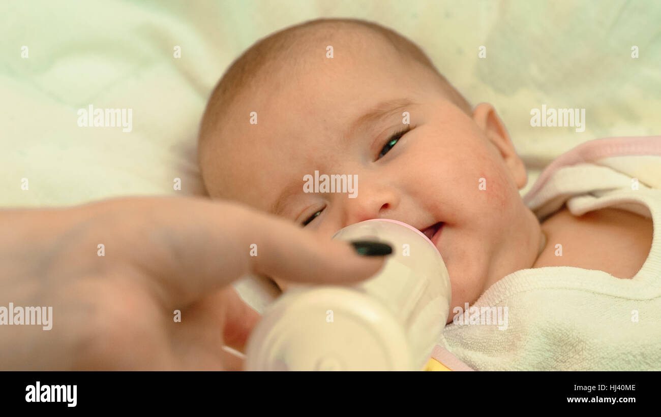 Little newborn baby drinking milk from a bottle Stock Photo - Alamy