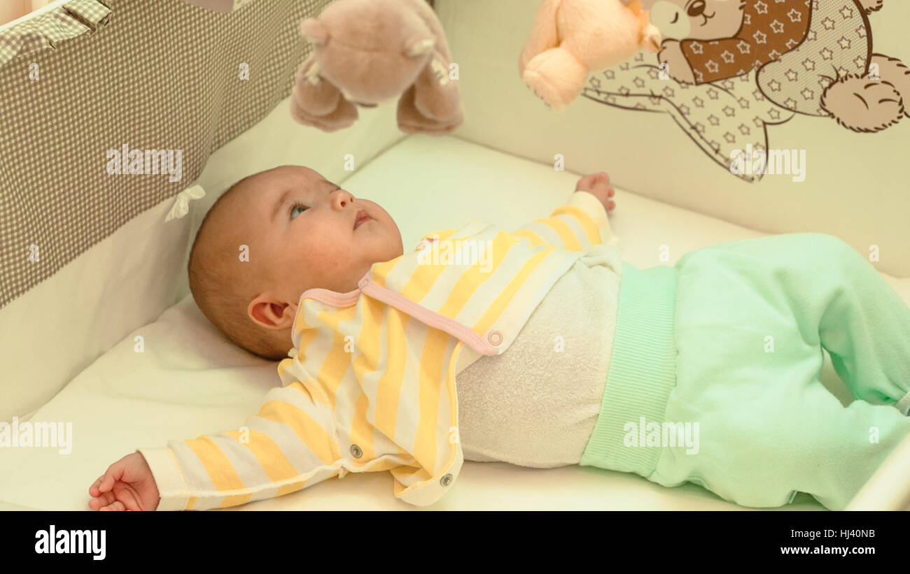 Little baby is resting in his crib Stock Photo - Alamy