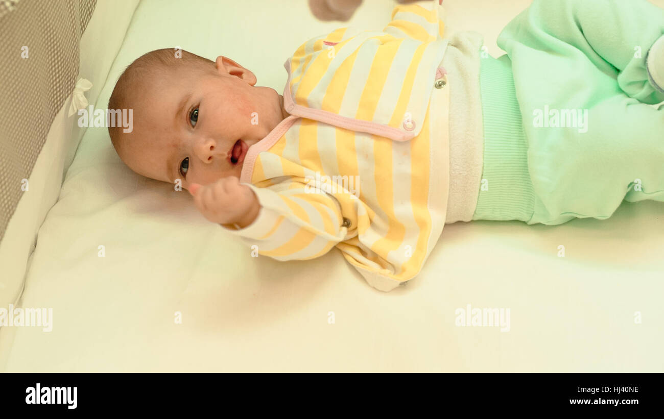 Little baby is resting in his crib Stock Photo - Alamy