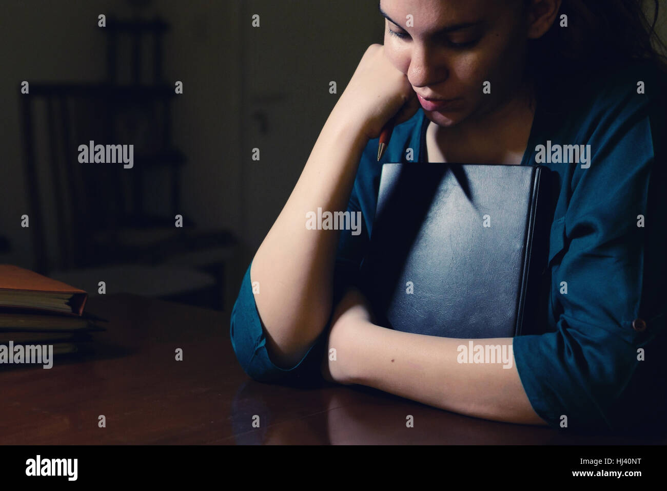 Young lady in her office thinking late at night Stock Photo - Alamy