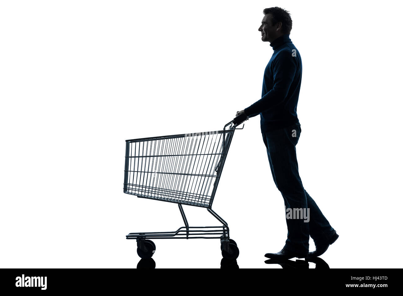 one caucasian man with empty shopping cart in silhouette studio ...