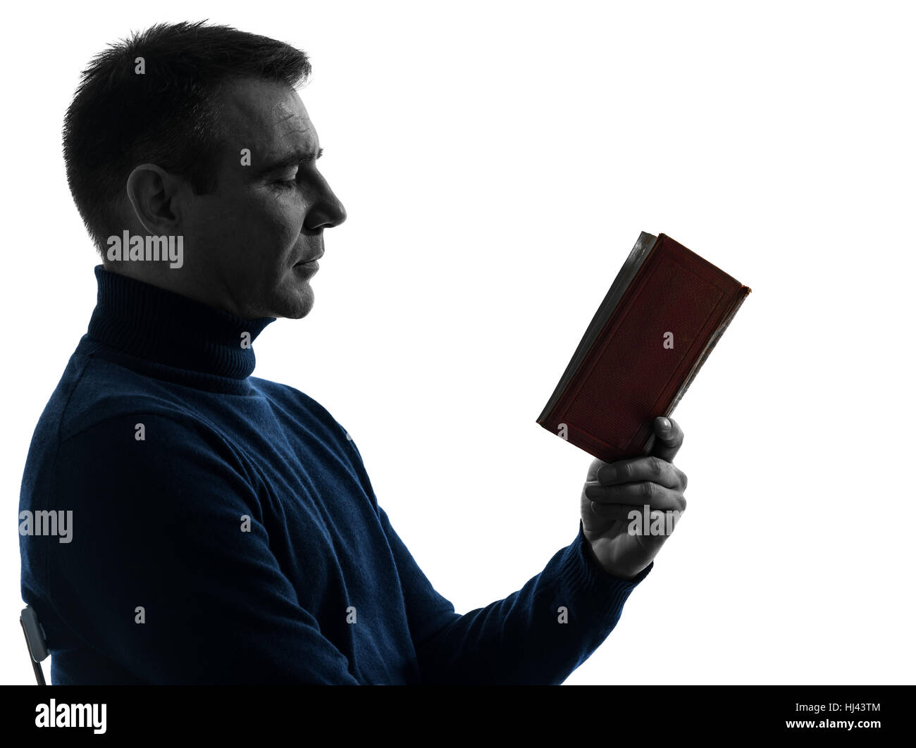 one caucasian man reading book portrait in silhouette studio isolated ...
