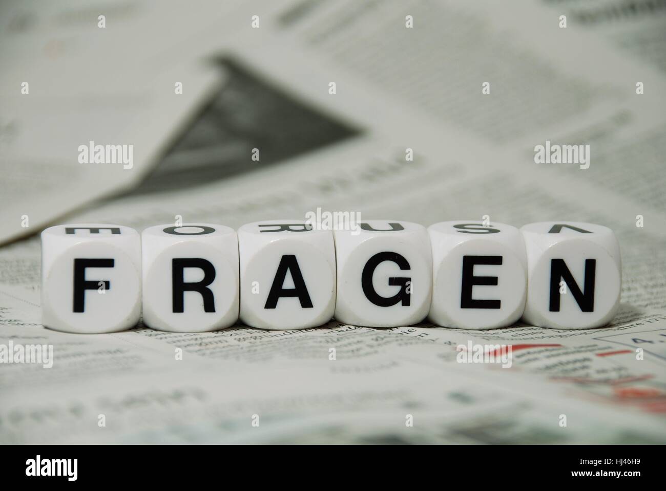 the word Fragen on a newspaper background Stock Photo - Alamy
