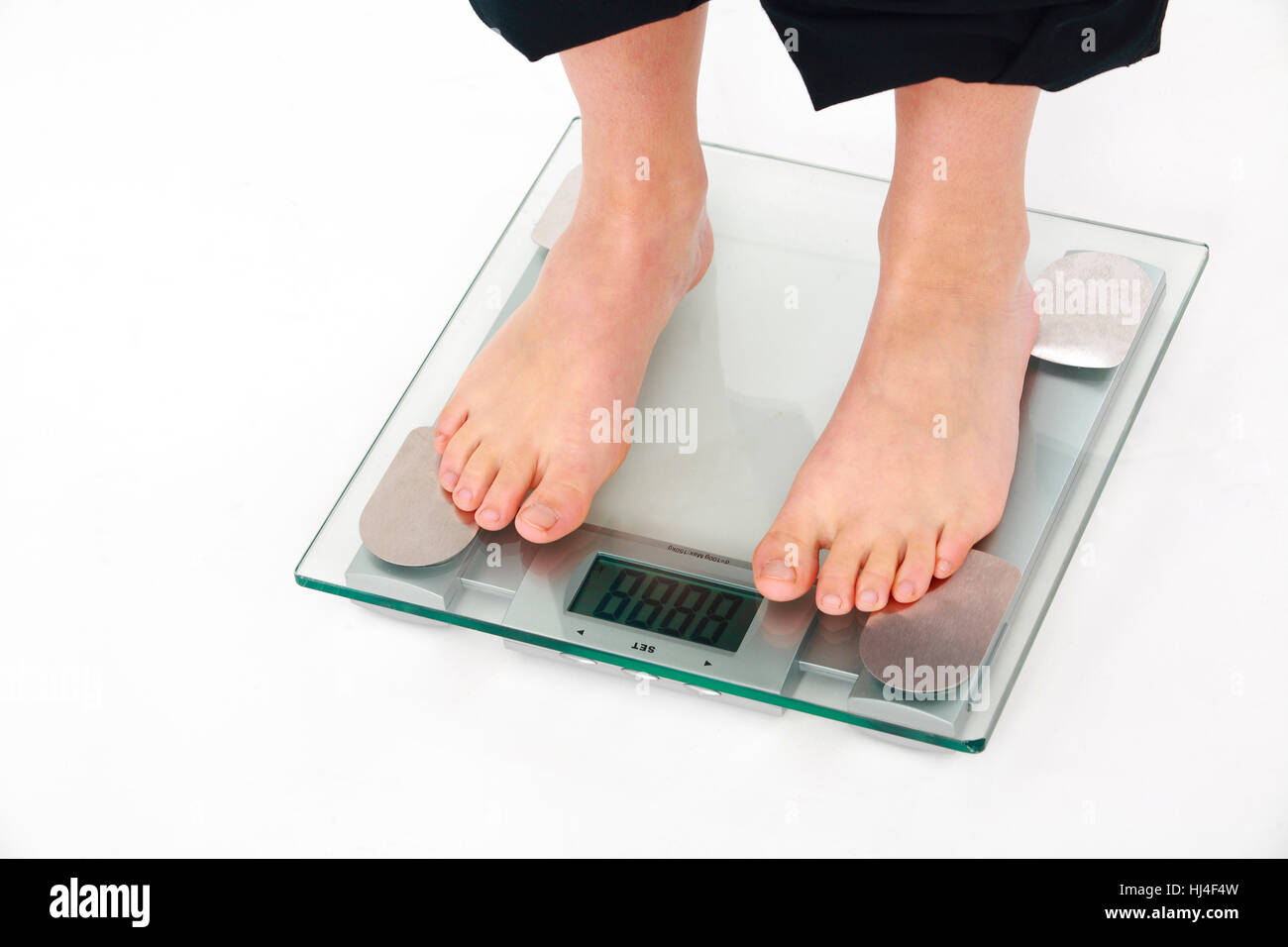 Female feet on scales Stock Photo - Alamy