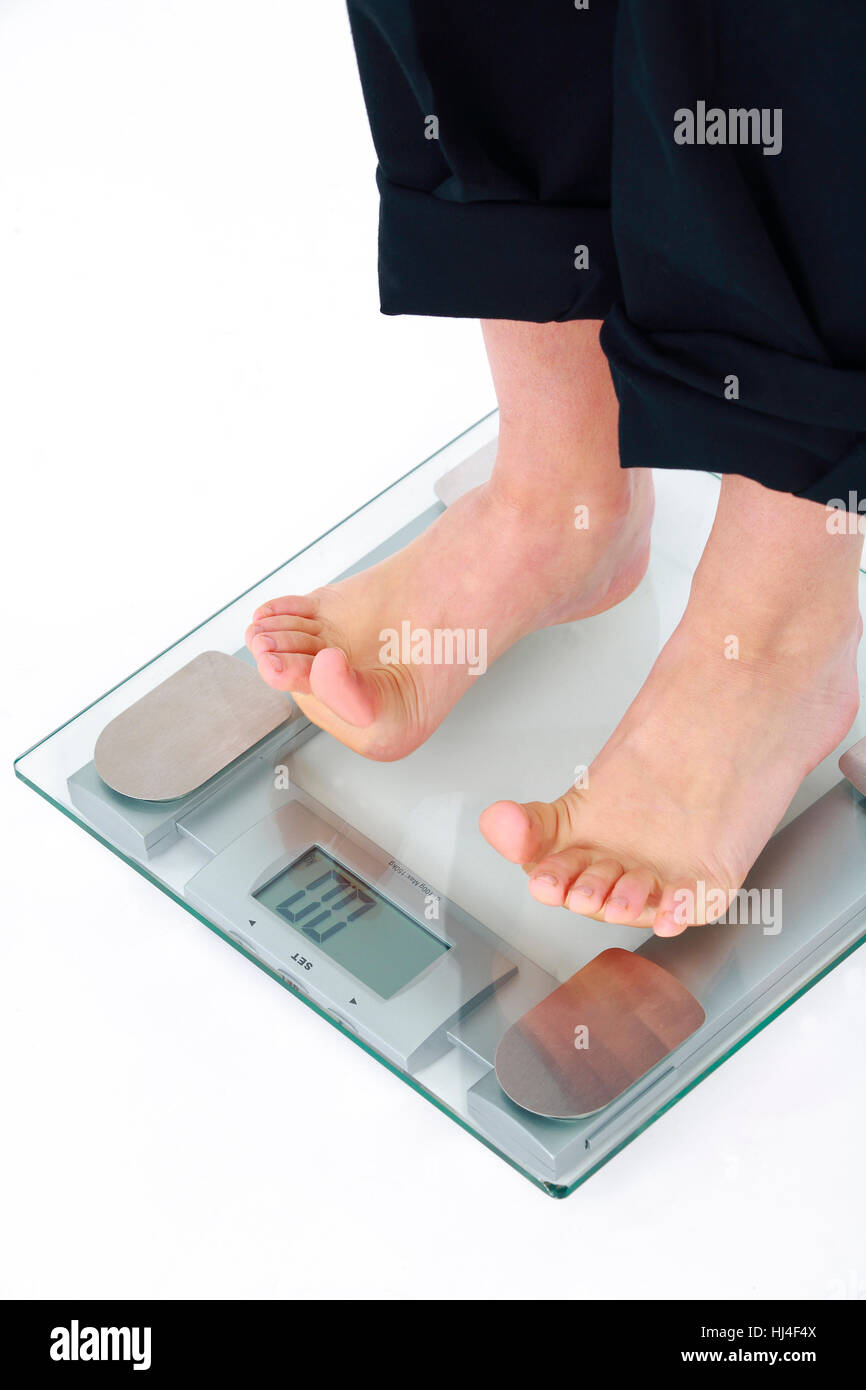 Female feet on scales Stock Photo - Alamy