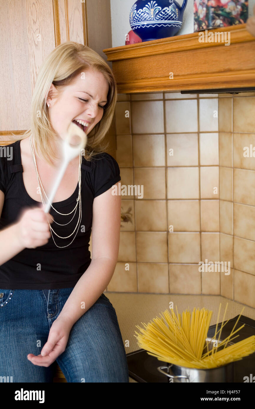 Young woman cooking spaghetti Stock Photo - Alamy