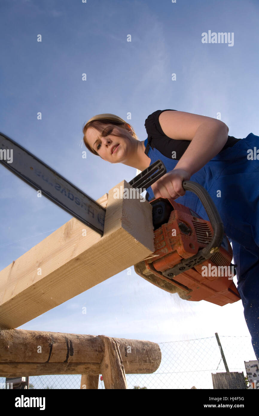 Young woman works with a chain saw Stock Photo - Alamy