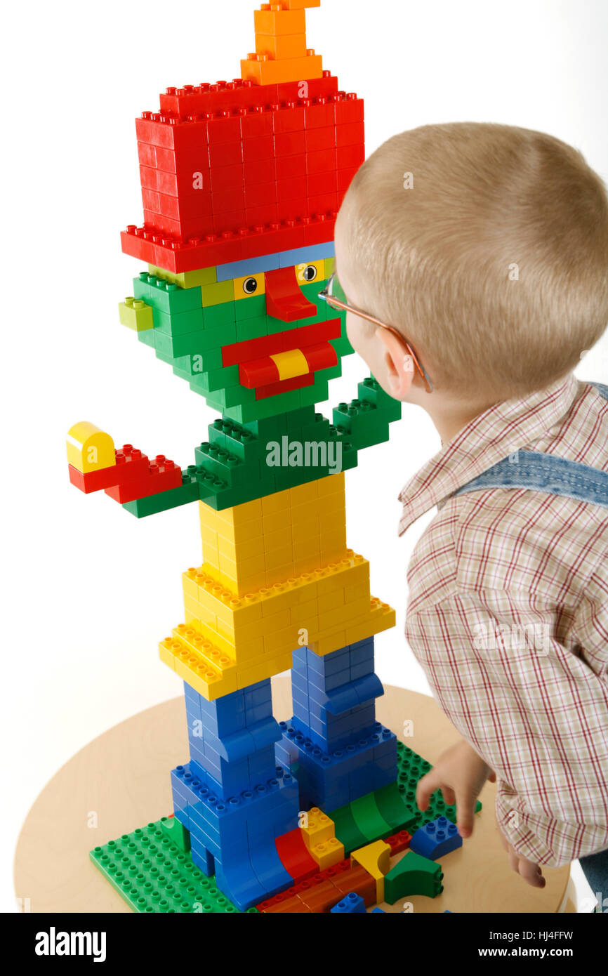 Little boy playing with bricks Stock Photo - Alamy