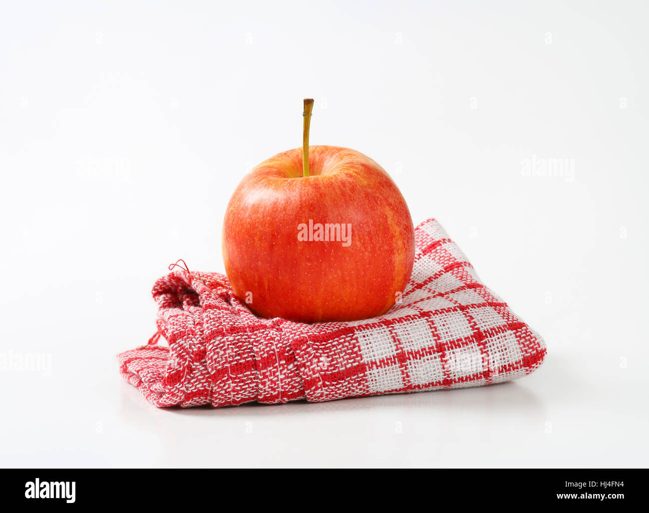 red ripe apple on checkered dishtowel Stock Photo - Alamy