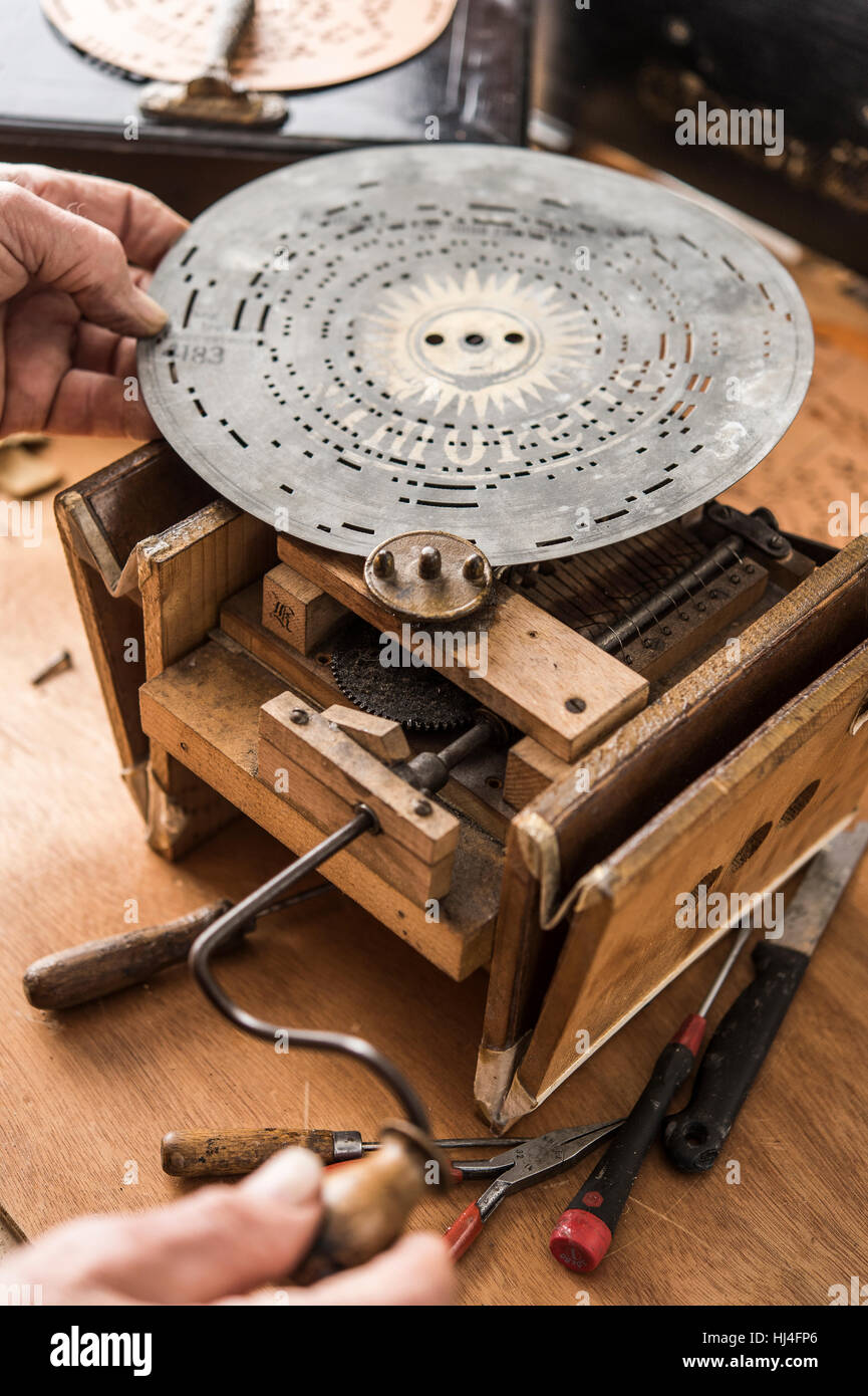 Barrel organ manufacture, perforated metal disk is placed on pin circle ...