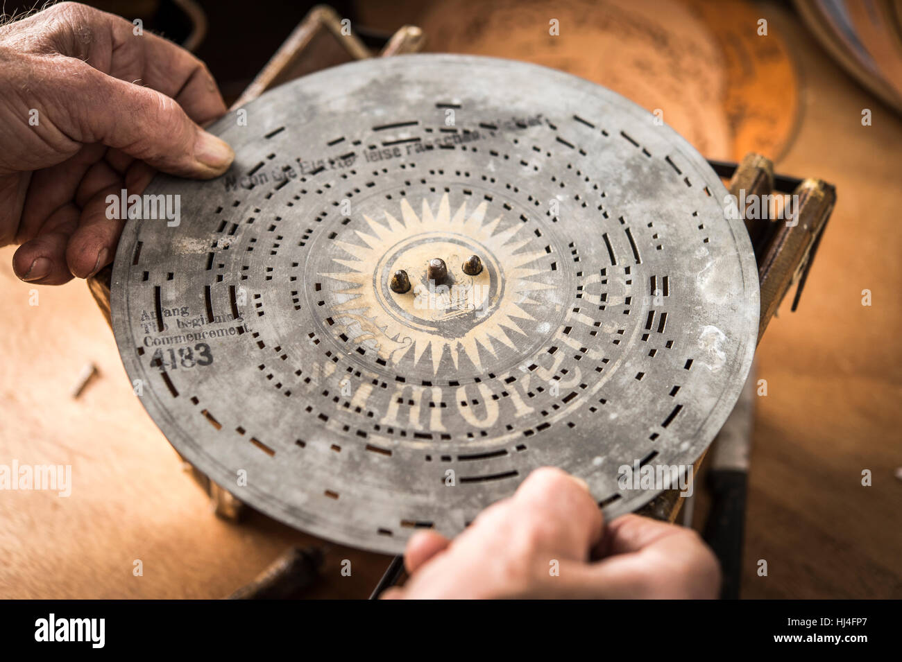 Barrel organ manufacture, perforated metal disk is placed on pin circle ...