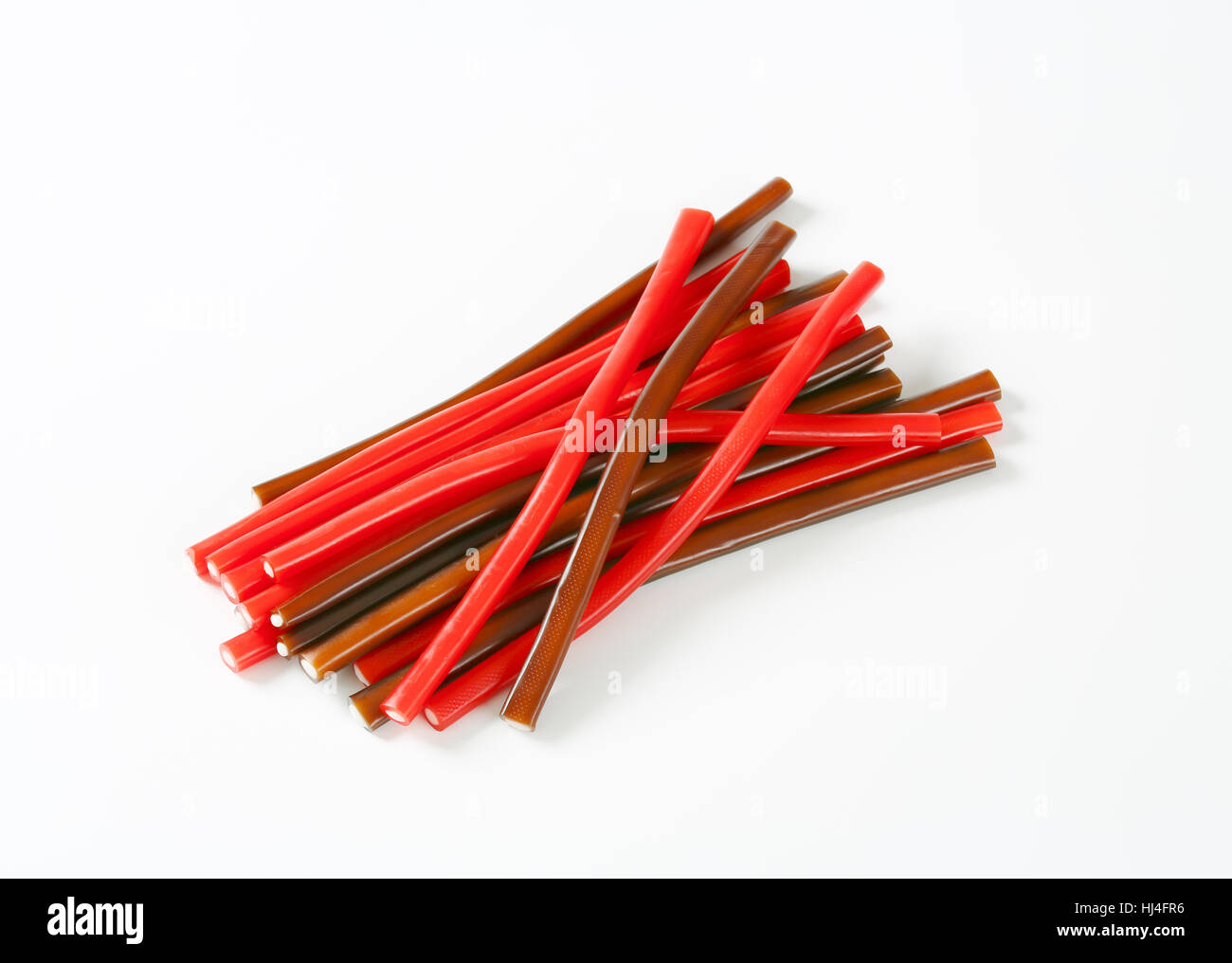 strawberry and cola candy sticks on white background Stock Photo - Alamy