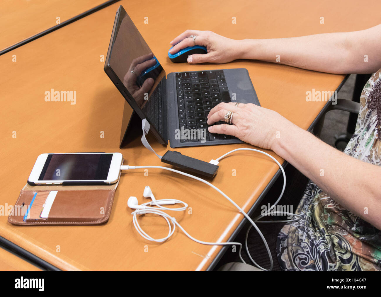 Connectivity concept woman using electronic devices that includes ...