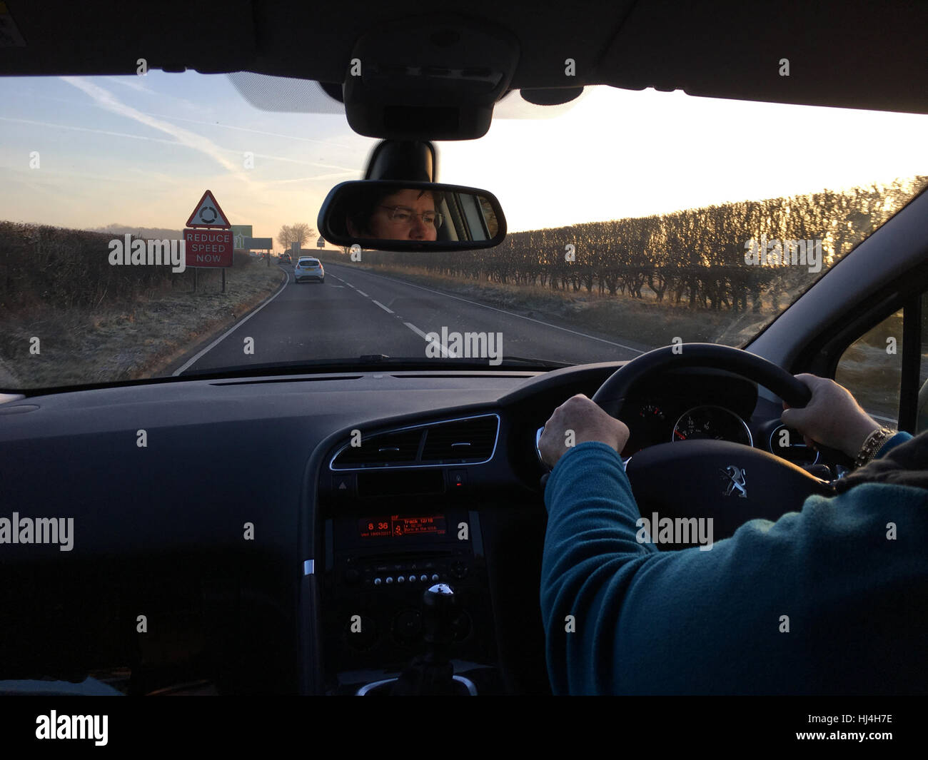One woman driving a car early morning hi-res stock photography and ...