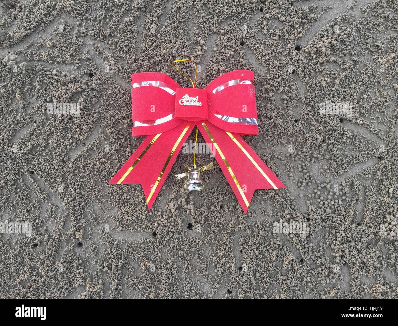Christmas chain, bell and ribbon for decoration on sandy beach Stock ...