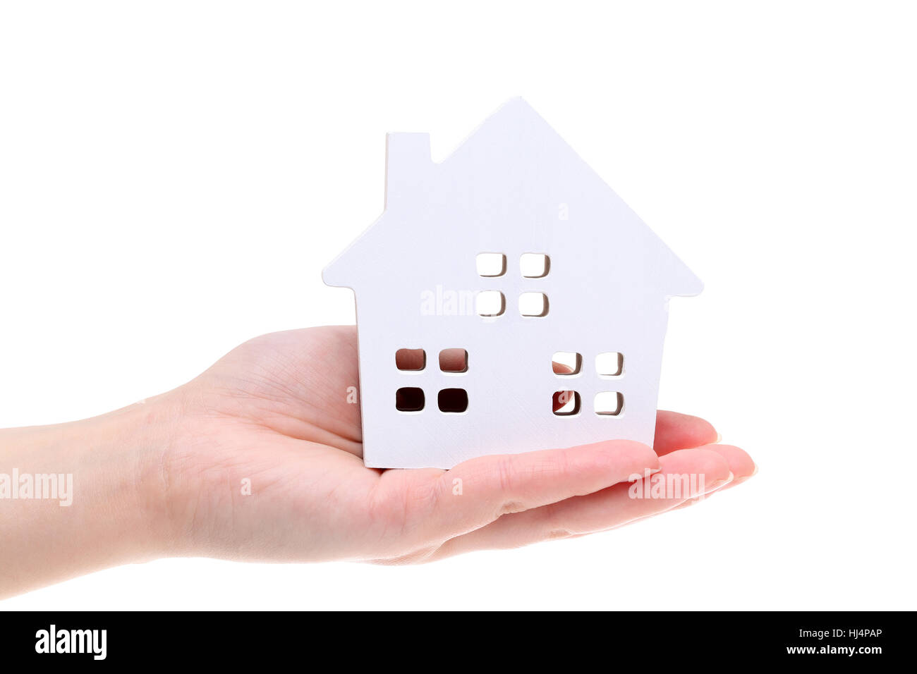 Miniature model of house on the hand, white background Stock Photo - Alamy