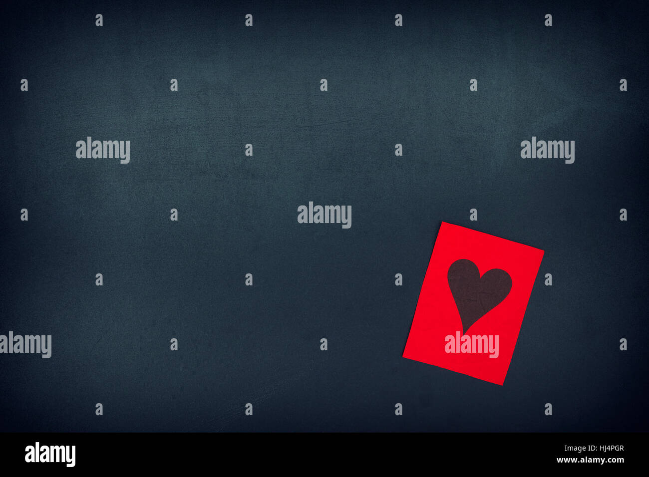 Red paper note with heart on a blackboard. Vignette Stock Photo - Alamy