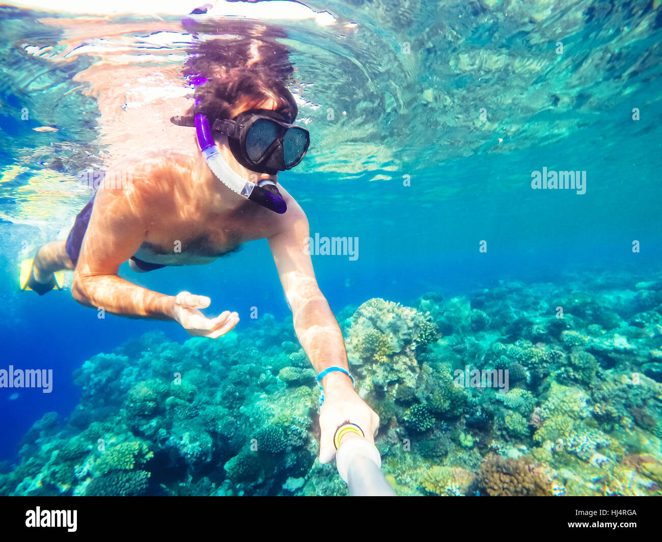 Underwater in the tropics paradise with snorkeling man, fish and coral ...