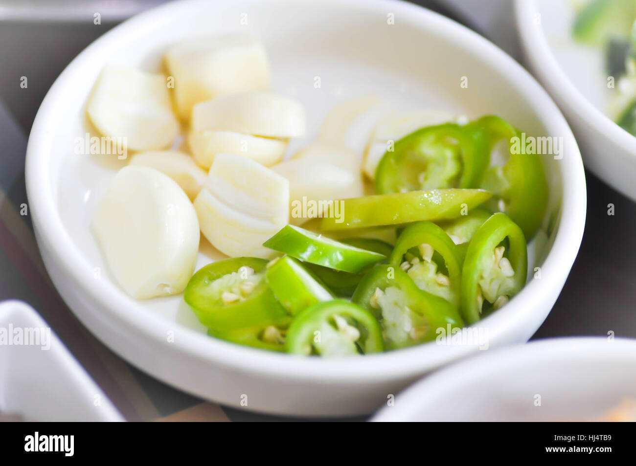 peeled garlic and cut chili in the dish Stock Photo - Alamy