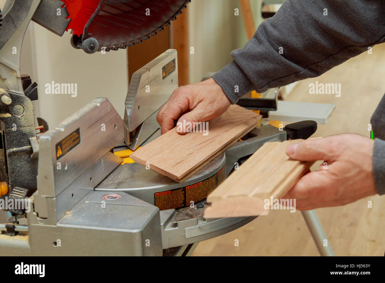 Construction worker, Trimming parquet on using circular miter saw for ...