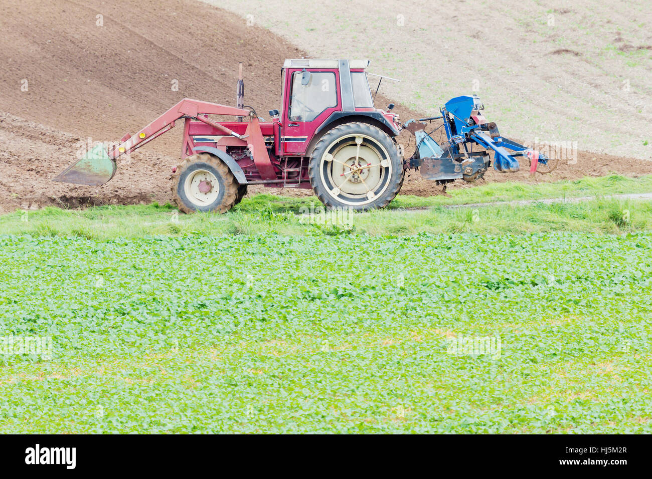 tractor in a field Stock Photo - Alamy