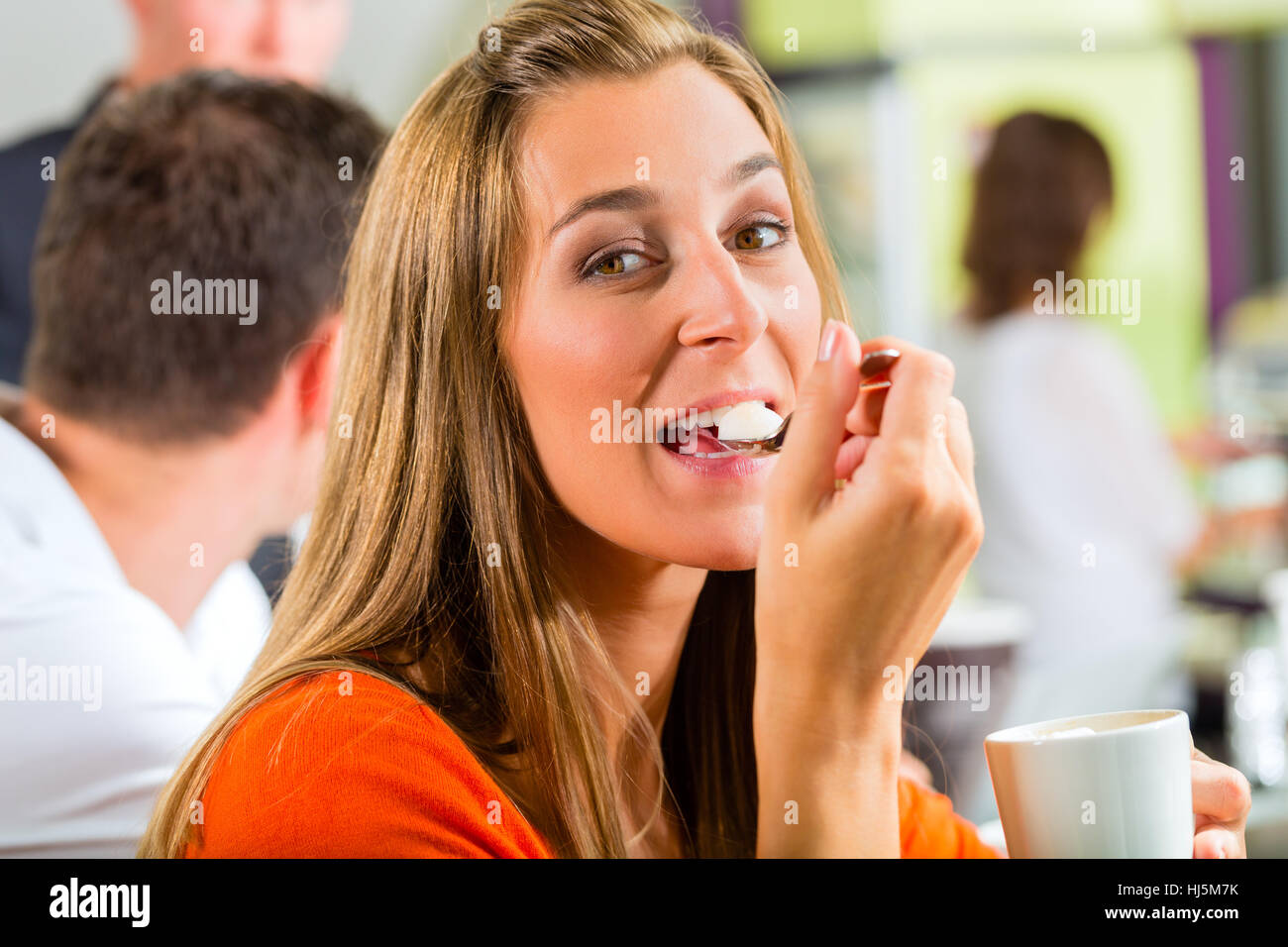 a young woman eating cream Stock Photo - Alamy