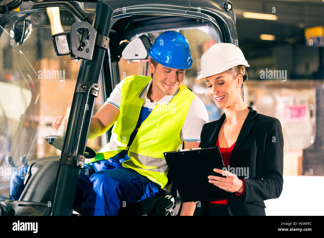 forklift driver and colleague,in storage of freight forwarding Stock ...