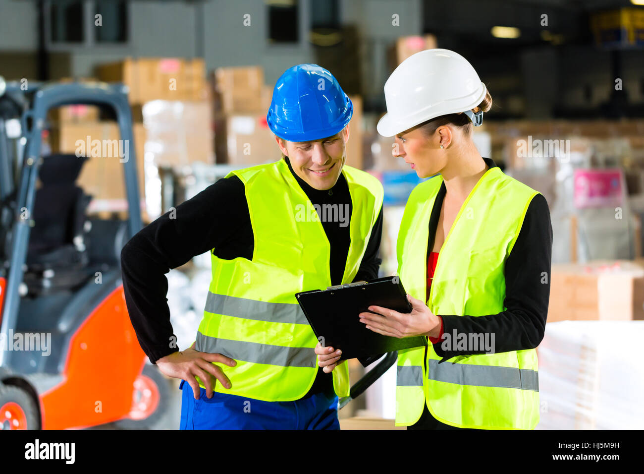 forklift driver and colleague,in storage of freight forwarding Stock ...