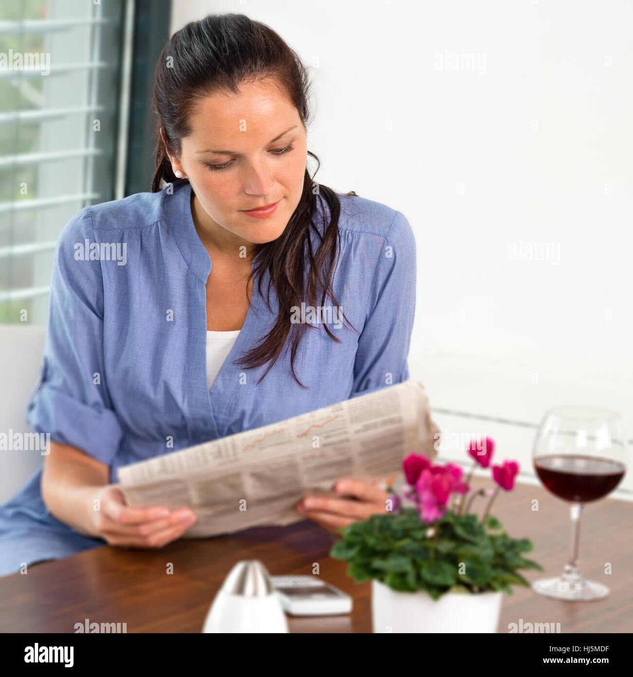 Woman alone reading newspaper laughing hi-res stock photography and ...
