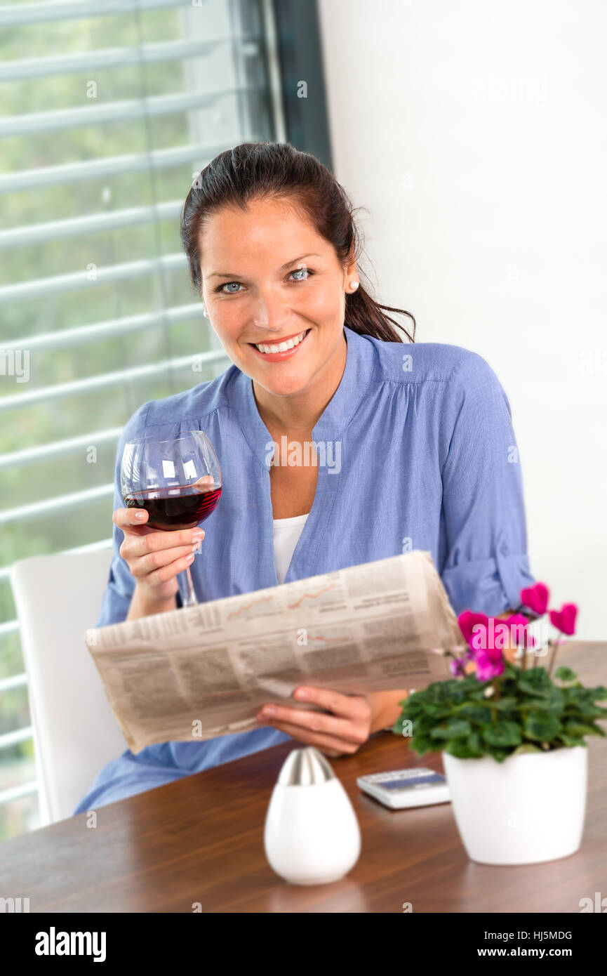 Woman alone reading newspaper laughing hi-res stock photography and ...