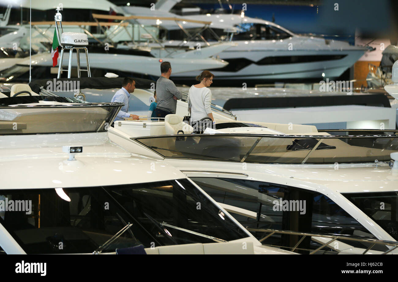 Visitors walk between yachts on display at the international boat ...
