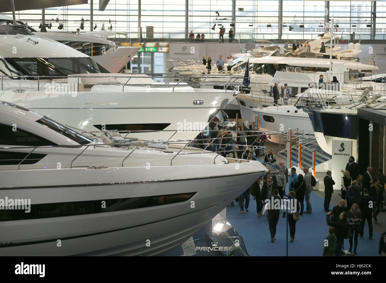 Visitors walk between yachts on display at the international boat ...