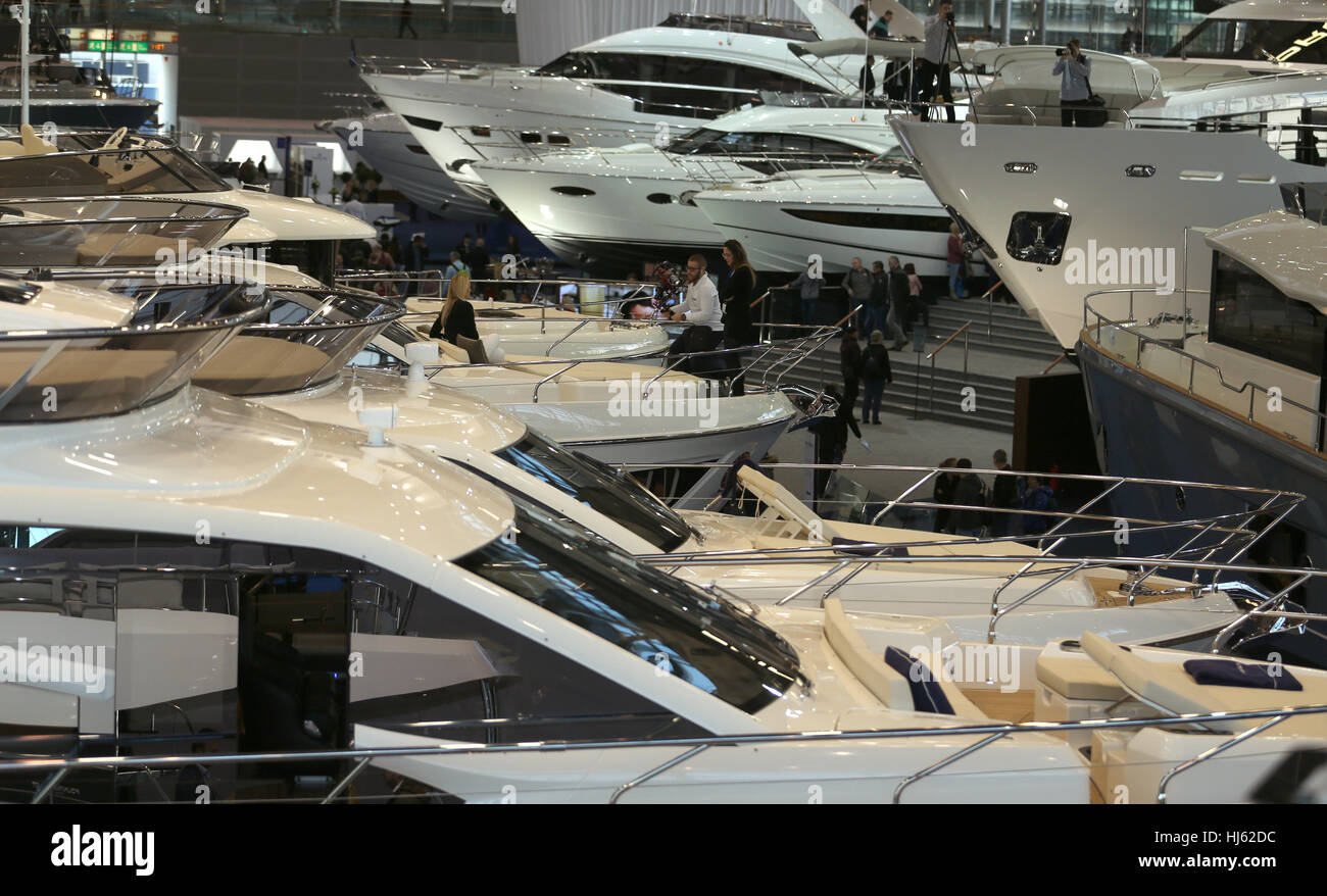 Visitors walk between yachts on display at the international boat ...